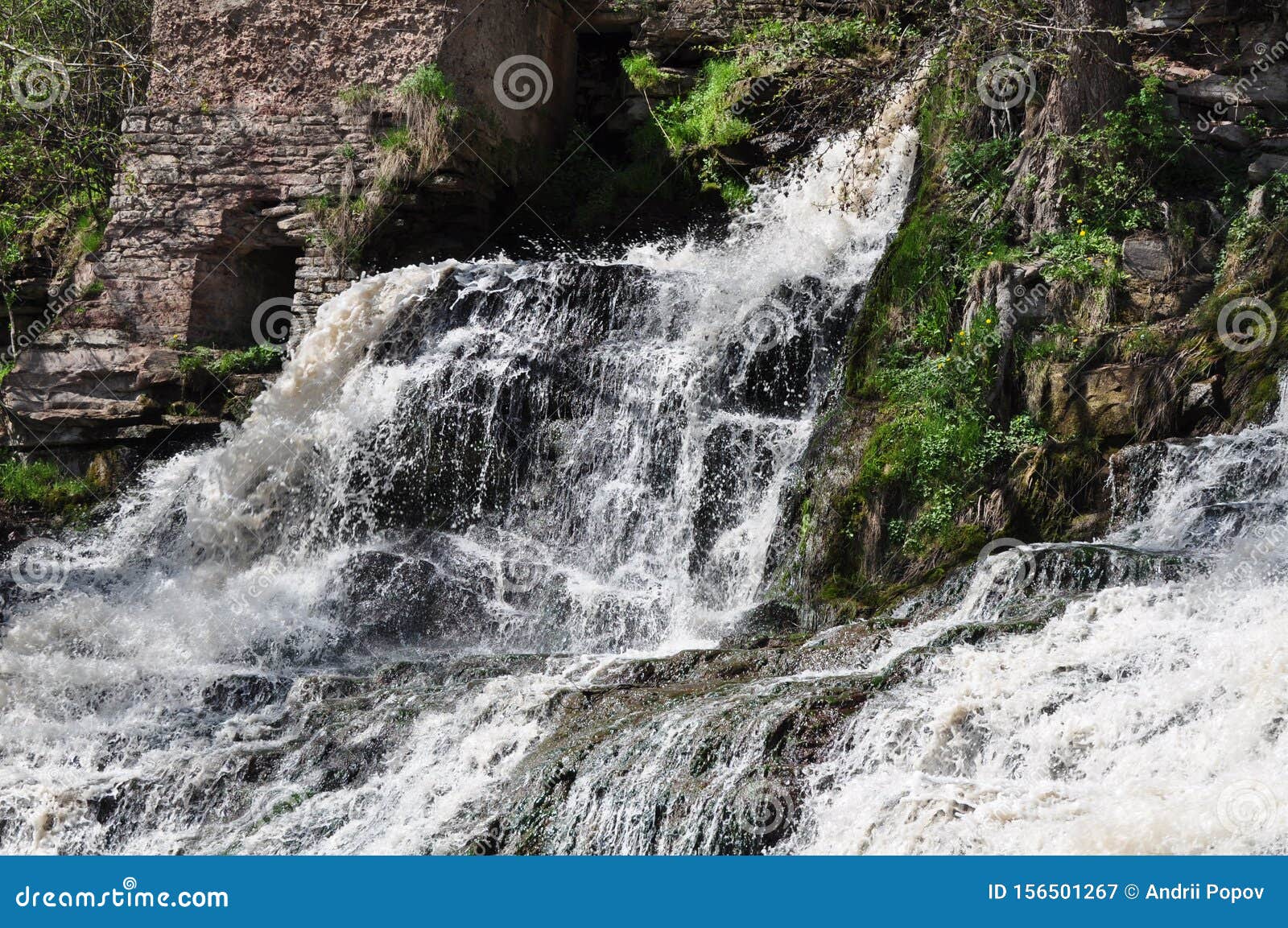 Waterfall among Stones and Spring Greens. Bubbling Water Stock Image ...