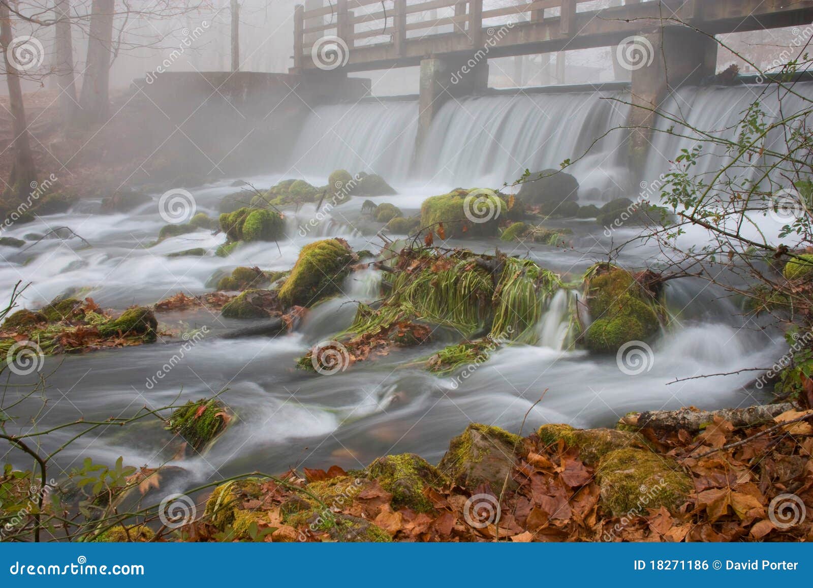 Waterfall Under a Bridge on a Foggy Fall Morning. Stock Photo - Image ...