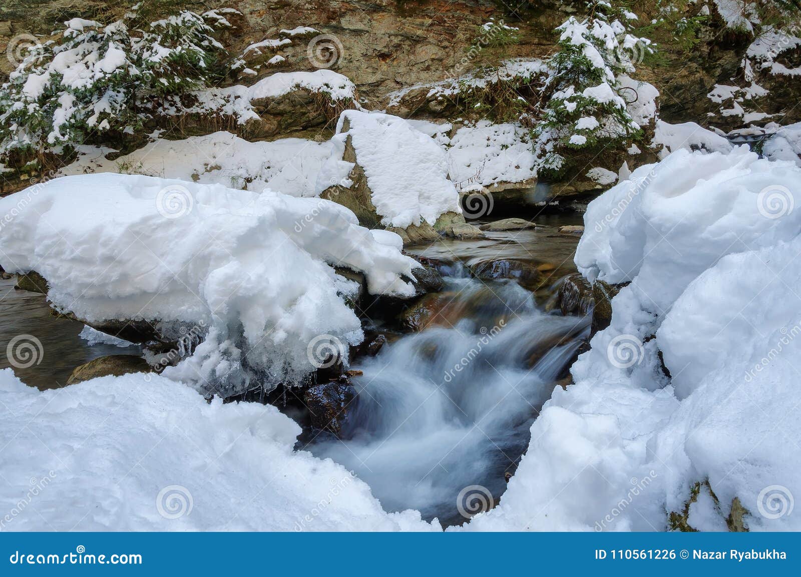 Waterfall in Winter. Mountain River and Snow on the Mountain Slopes ...