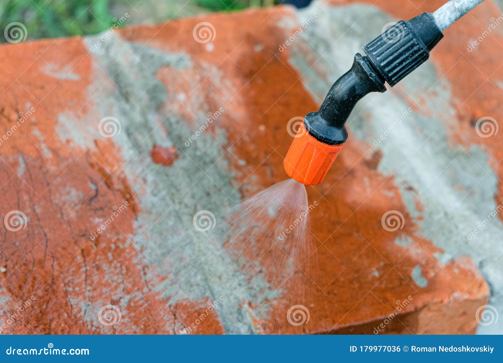 Watering of Red Ceramic Brick Masonry Using Stock Photo - Image of ...