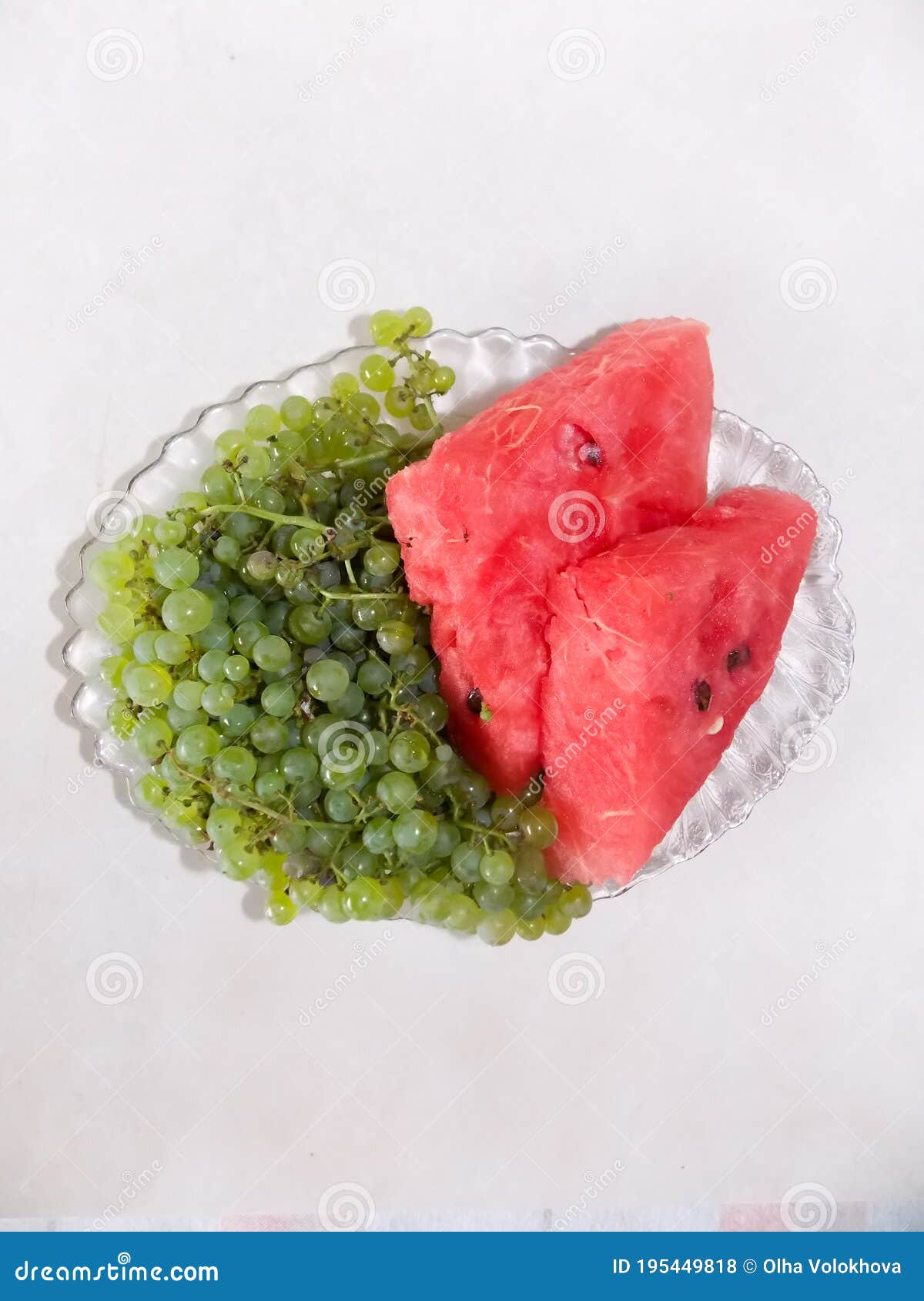 Watermelon with Grapes in a Plate on a White Background Stock Photo ...