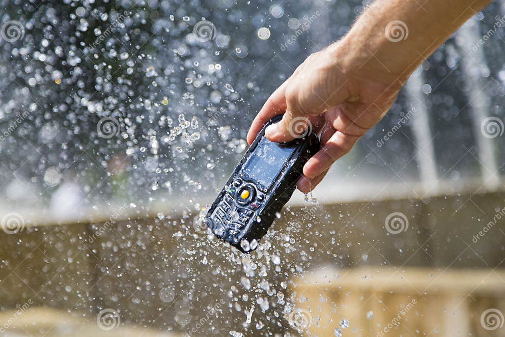 Testing a Rugged Mobile Phone Stock Photo - Image of spray, holiday ...