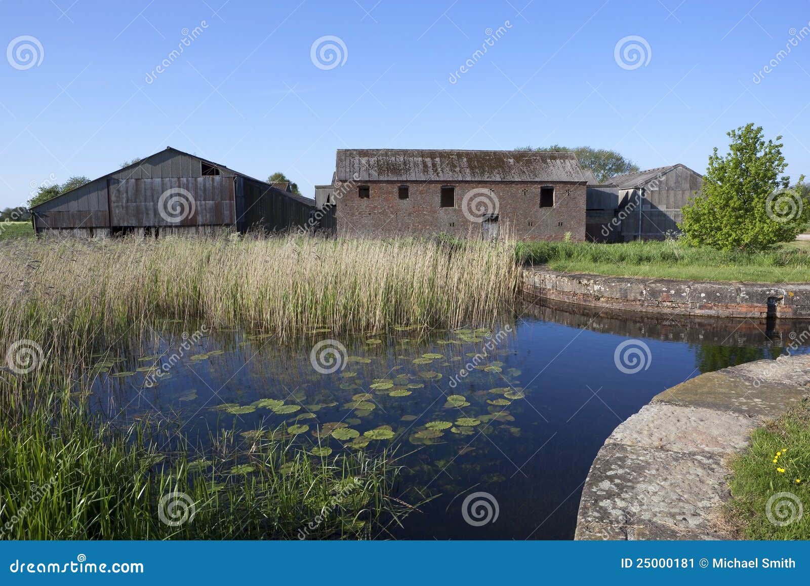 Waterside barns stock image. Image of water, scenery - 25000181