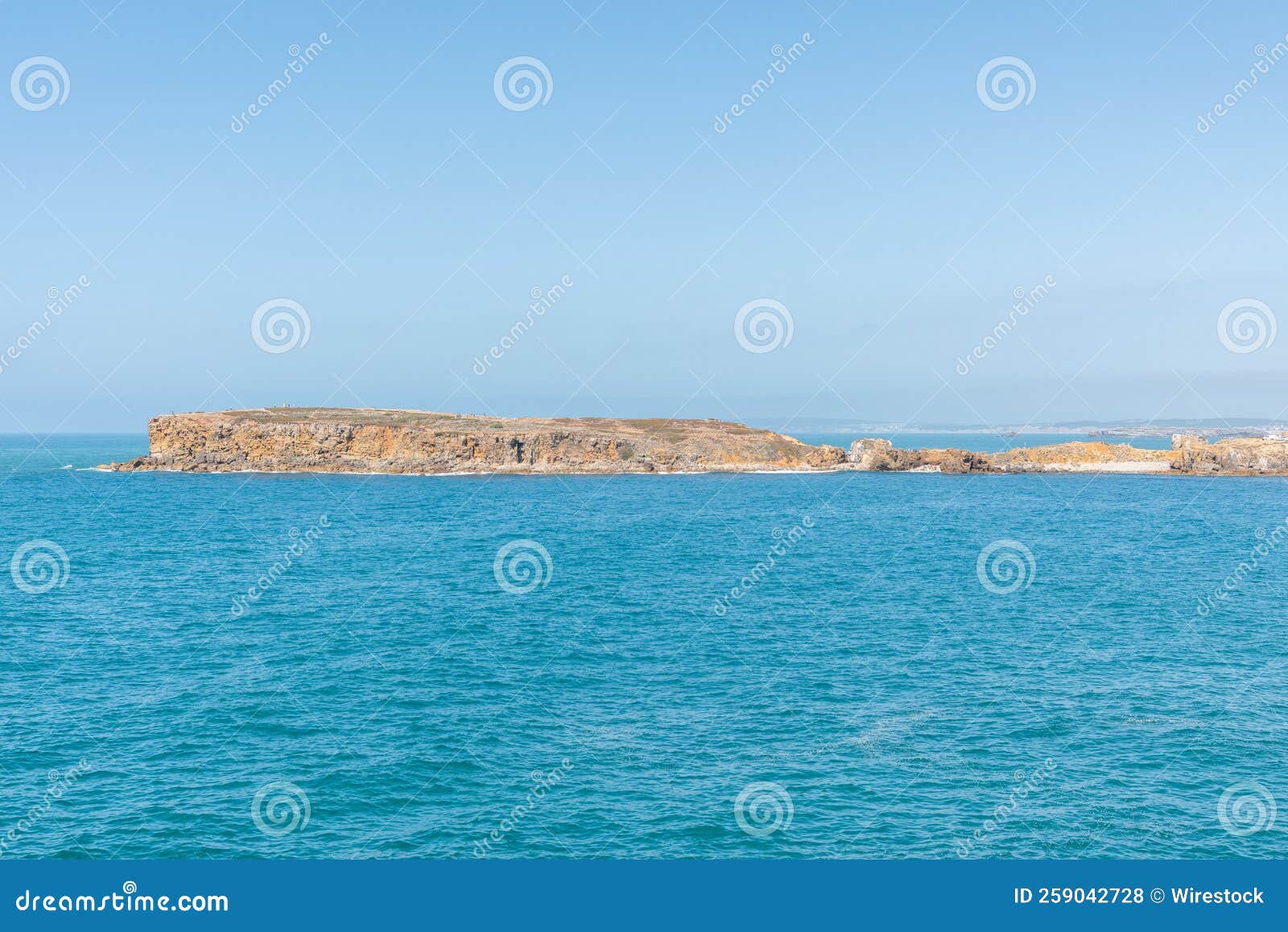 Waterside View of the Ilheu Da Papoa Cliffs Under the Blue Sky Stock ...