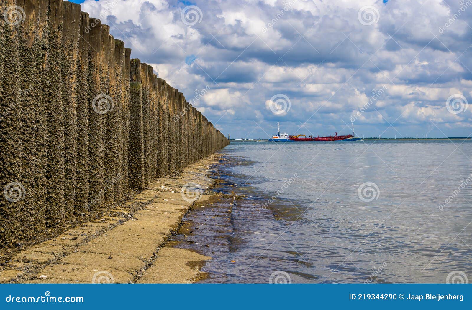 Wave Breakers with a Transport Ship Sailing on Sea, Breskens Beach ...