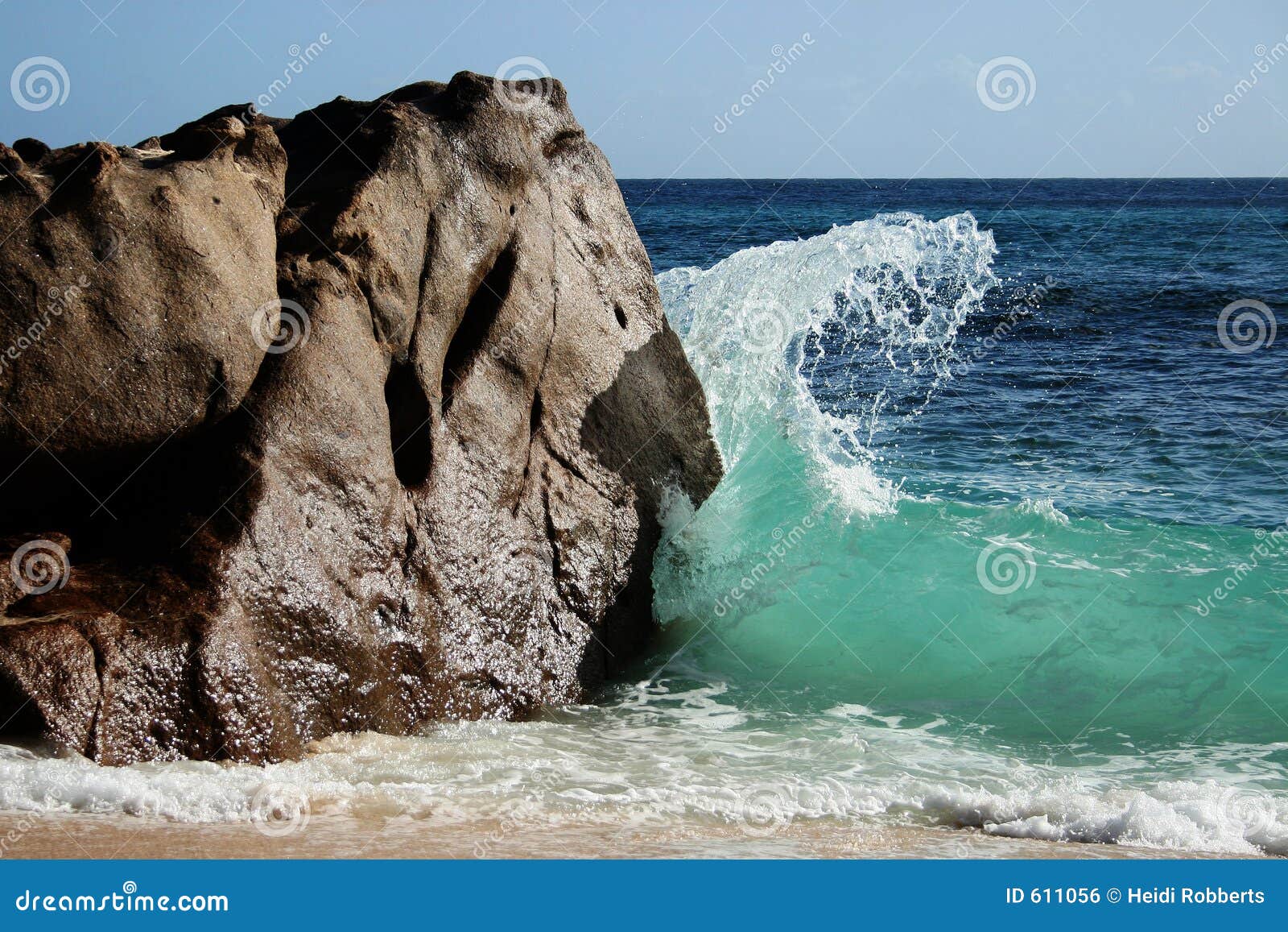 Wave breaking against rock stock photo. Image of boulder - 611056