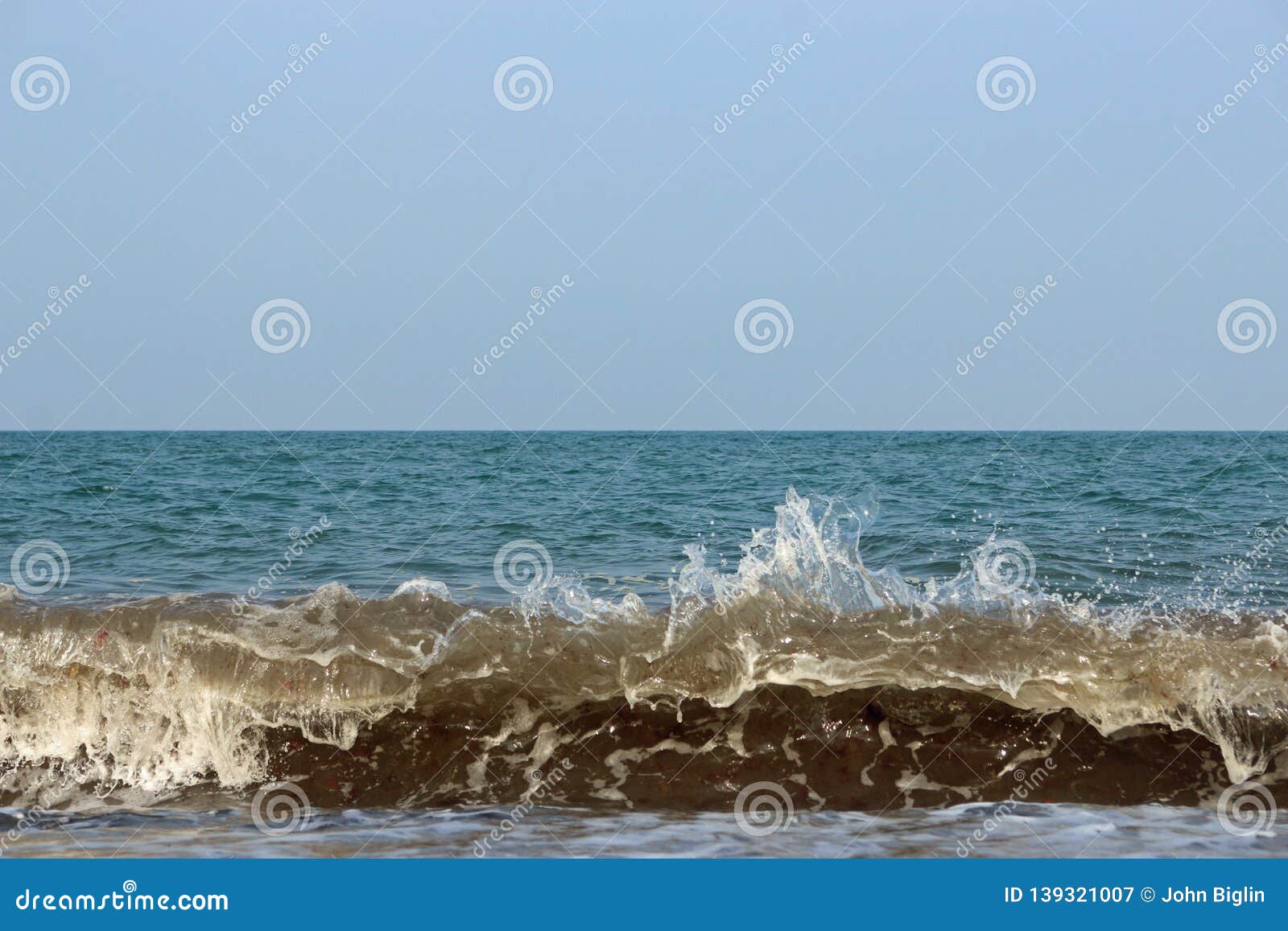Wave breaking on the beach stock image. Image of breaking - 139321007