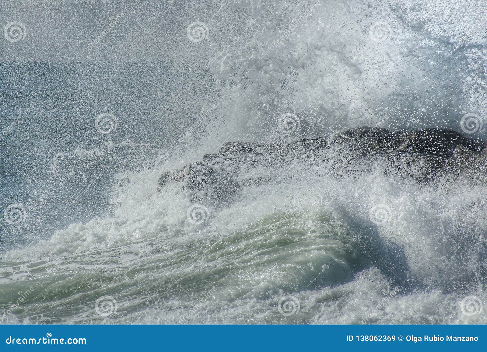 Wave breaking in the rocks stock image. Image of wave - 138062369