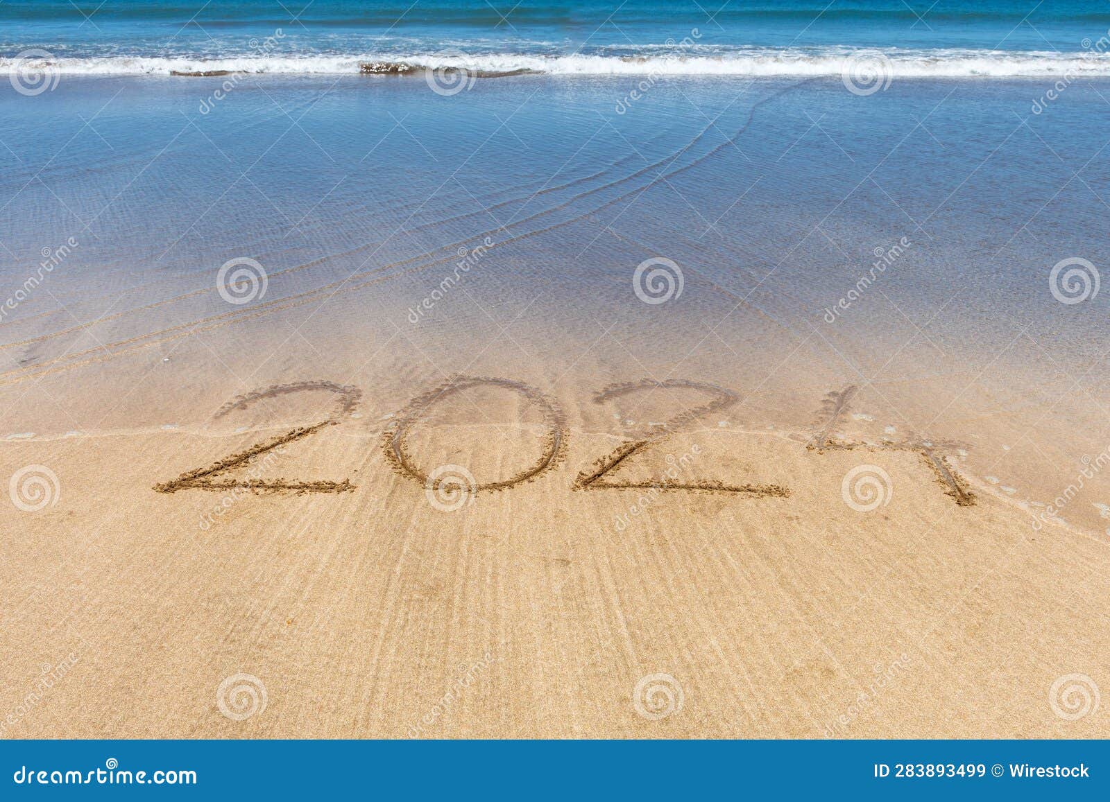 Wave Erasing a 2024 Written in the Sand on the Seashore. Stock Image ...