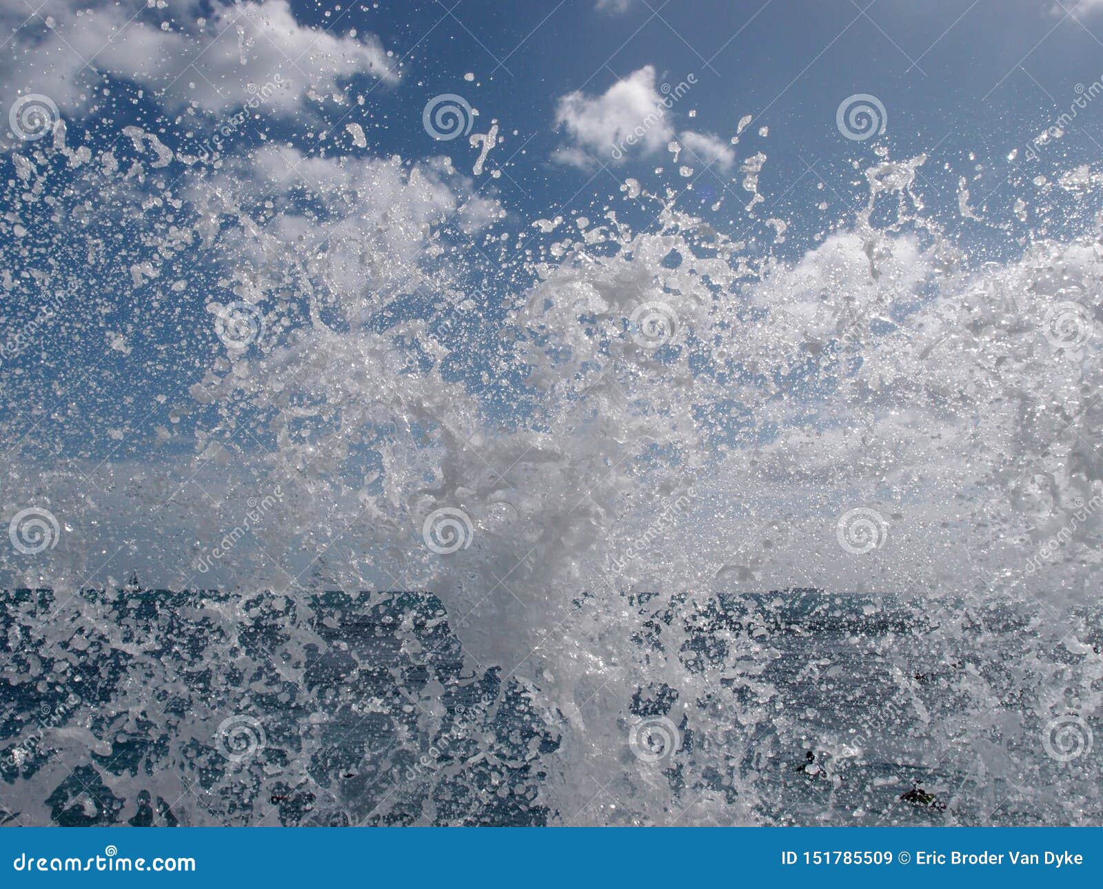 Wave Explodes into the Air with Blue Cloud Sky in the Background Stock ...