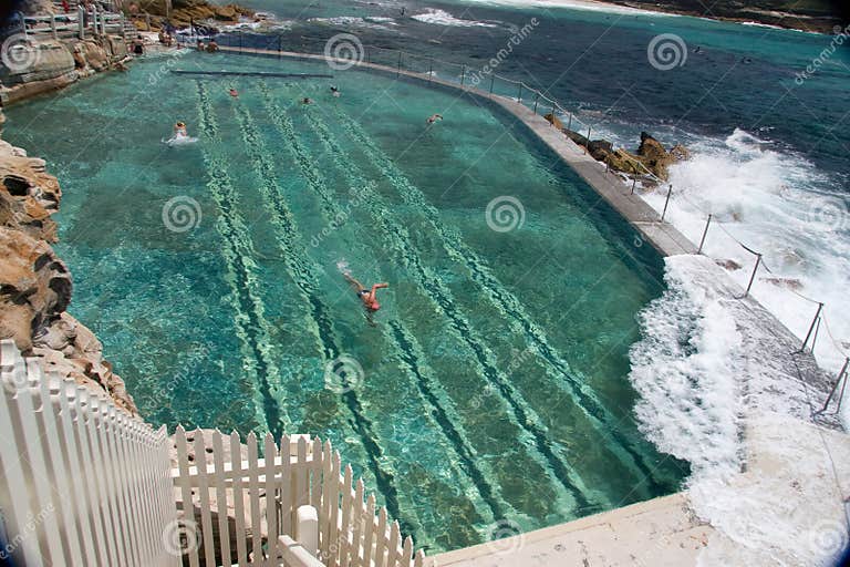 Wave Hitting a Natural Pool with Swimmers Editorial Photography - Image ...