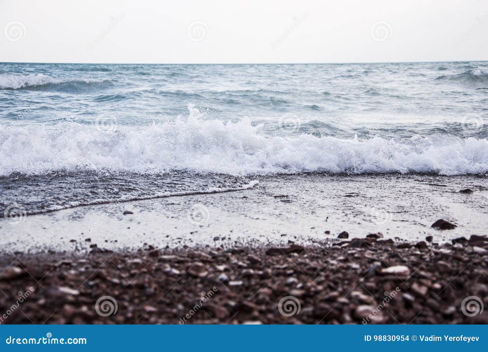 Sea wave and pebble beach stock photo. Image of rock - 98830954
