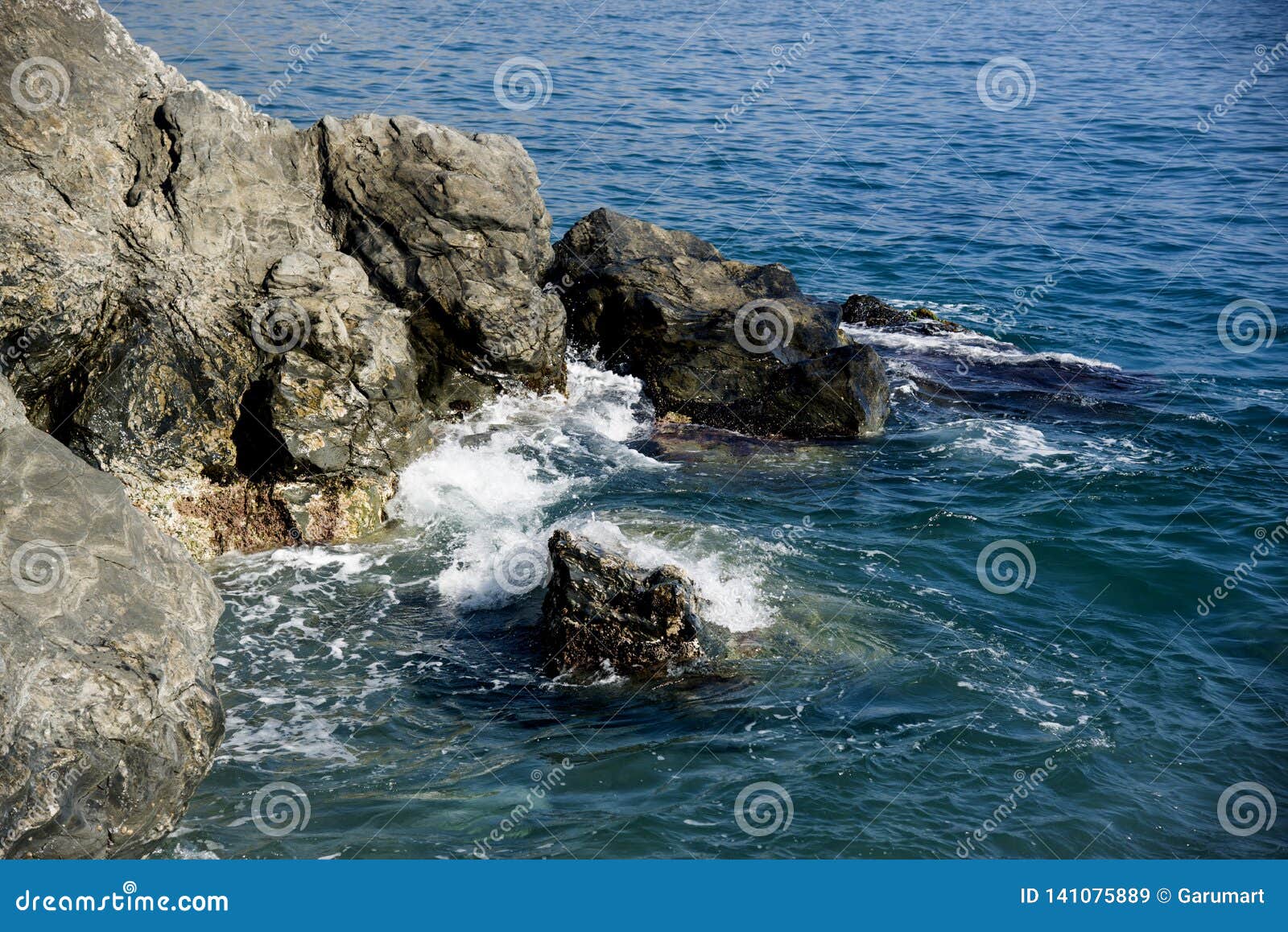 Wave and rocks by the sea stock image. Image of nature - 141075889