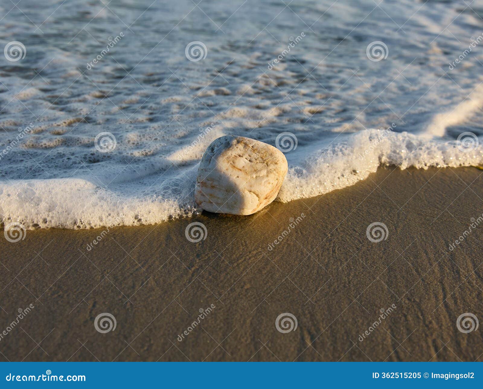 Wave Surrounds a Rock on the Sand Stock Image - Image of natural ...