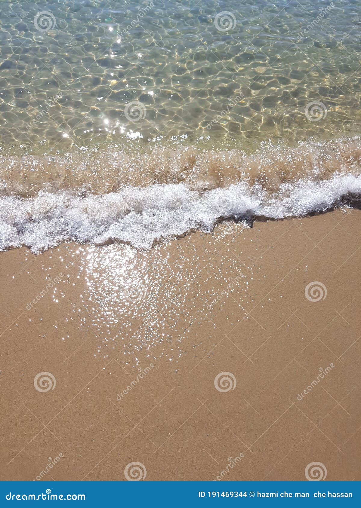 Waves against a beach sand stock photo. Image of sand - 191469344