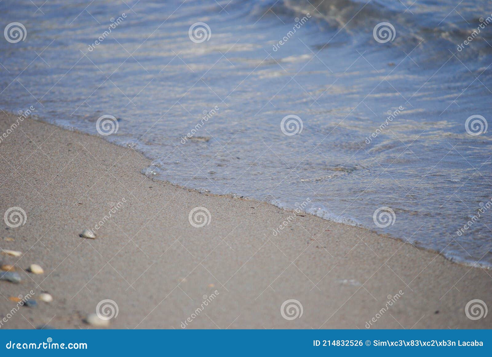 Waves on the beach sand stock photo. Image of travel - 214832526