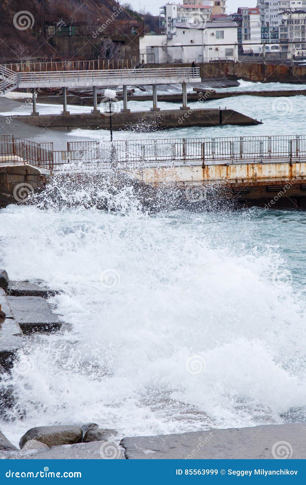 The Waves Break on the Old Jetty and the Rocks. Autumn is Overcast and ...