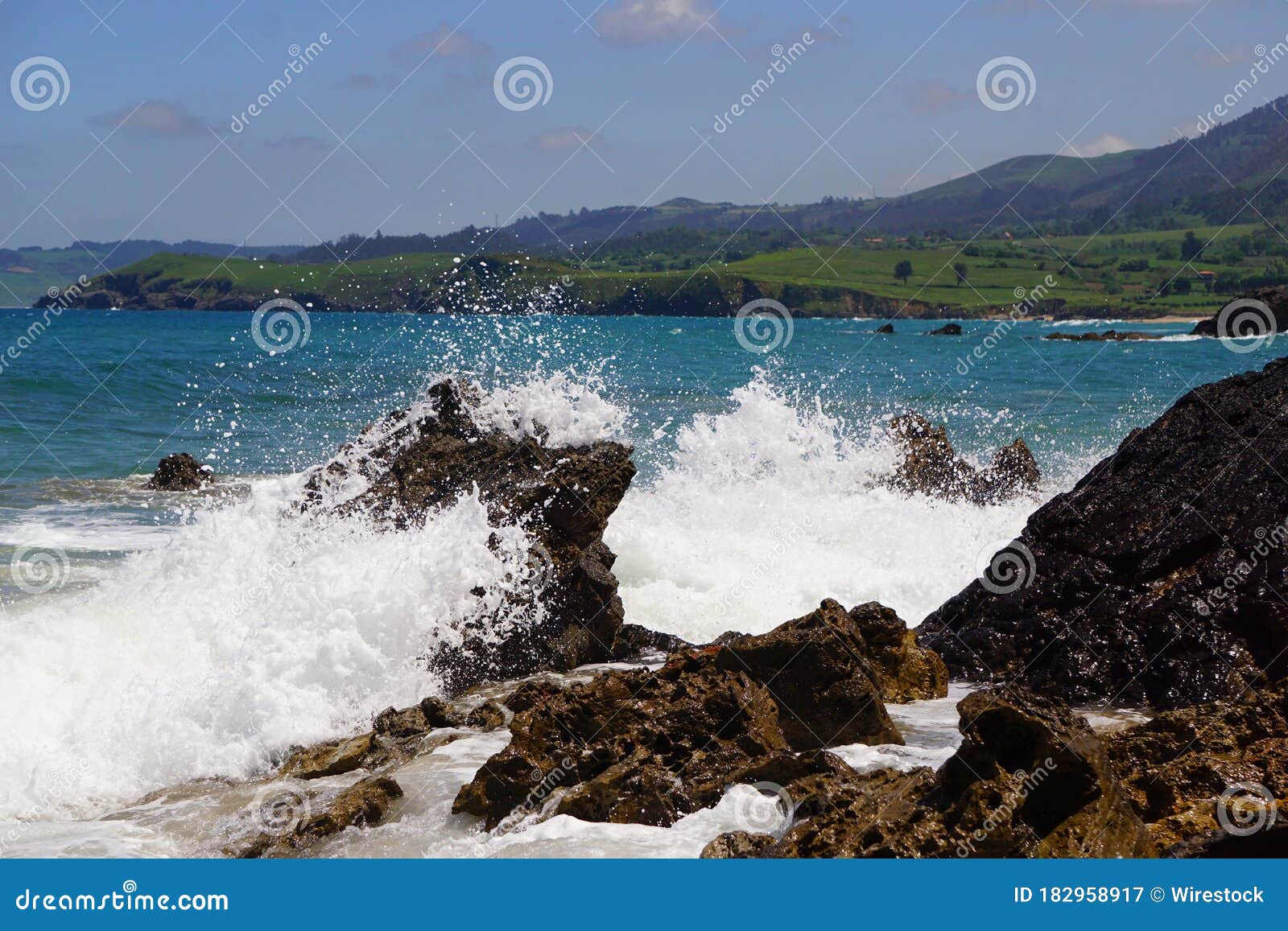 Waves Breaking Onto Rocks with a Blue Ocean Behind Them Stock Image ...