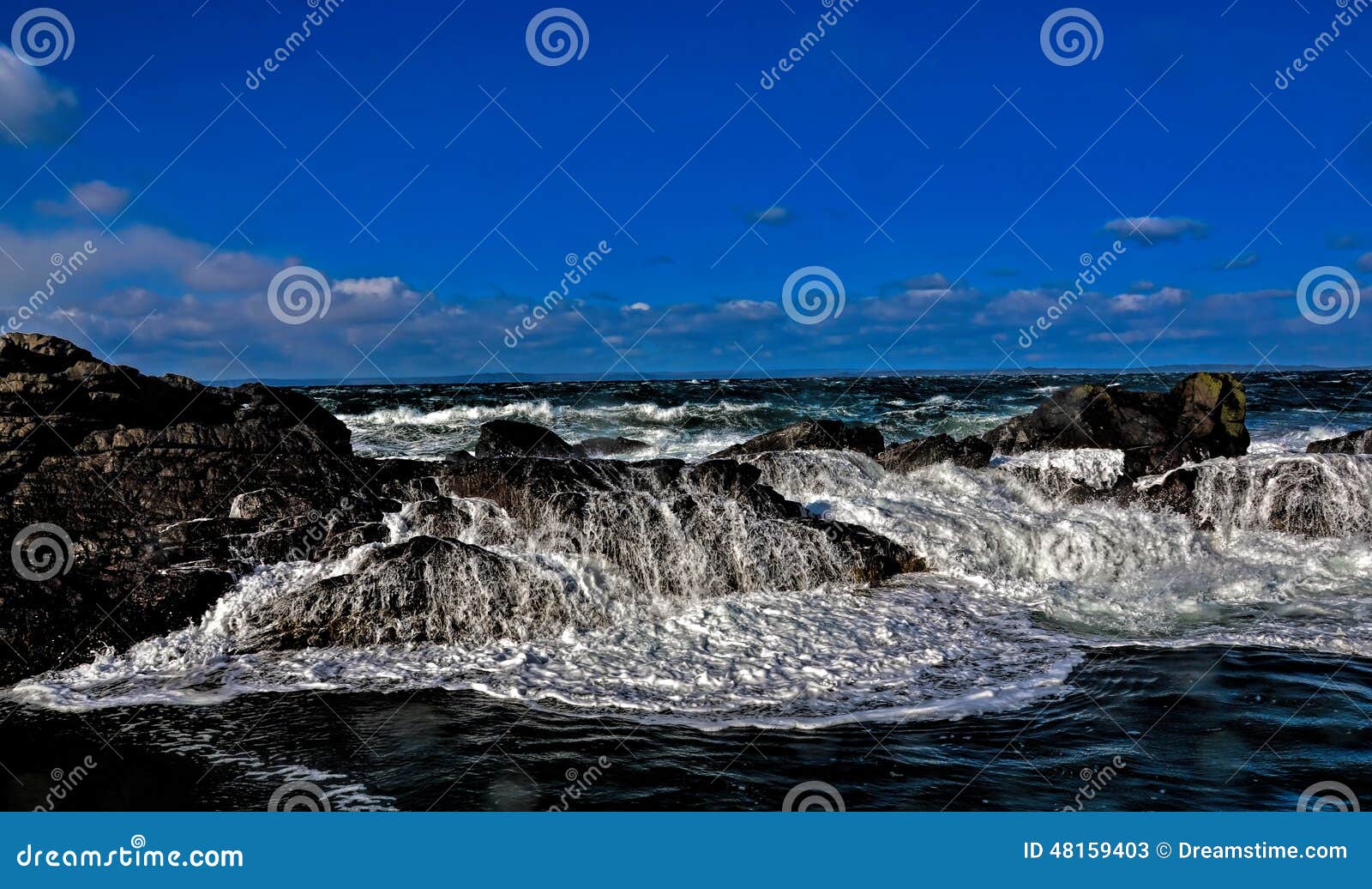 Waves breaking over rocks stock image. Image of crashing - 48159403