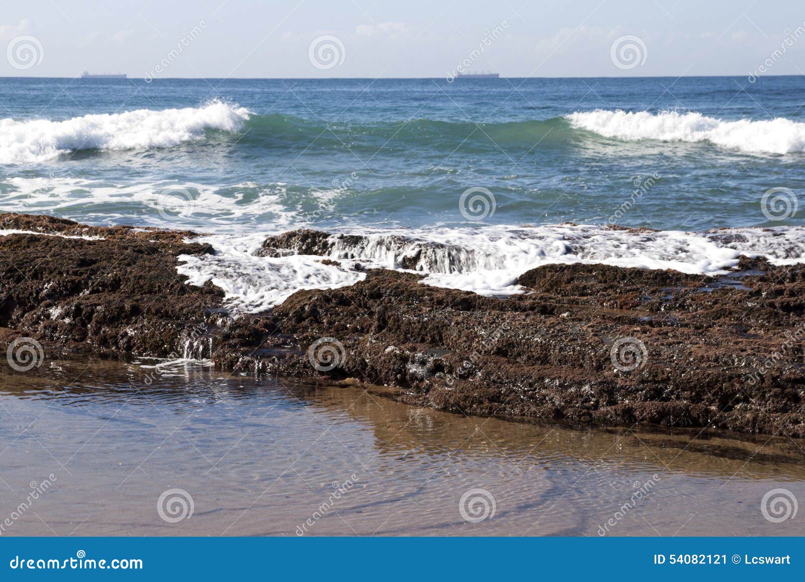 Waves Breaking Over Rocks Covered with Seaweed and Barnacles Stock ...