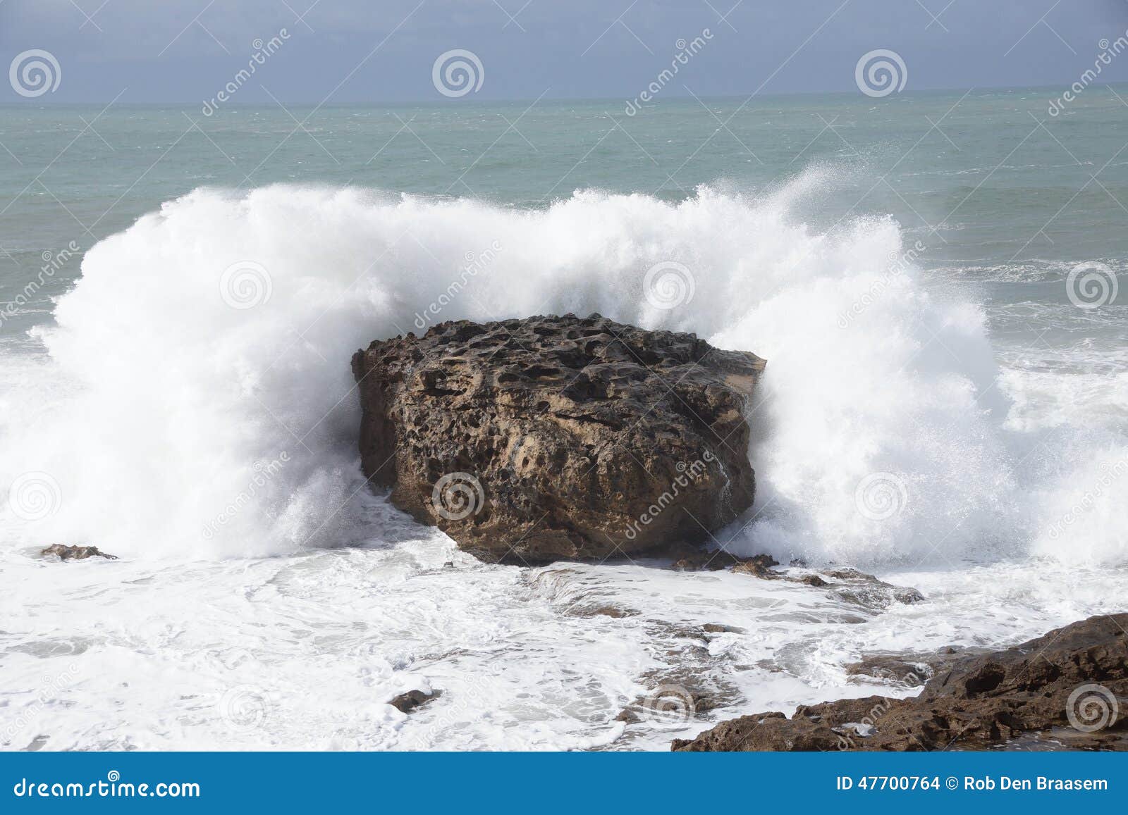Waves breaking over rocks stock photo. Image of high - 47700764