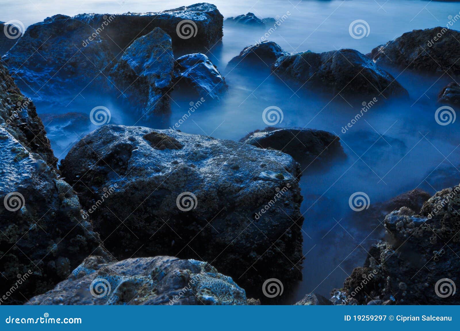 Waves breaking on rocks stock image. Image of outdoors - 19259297
