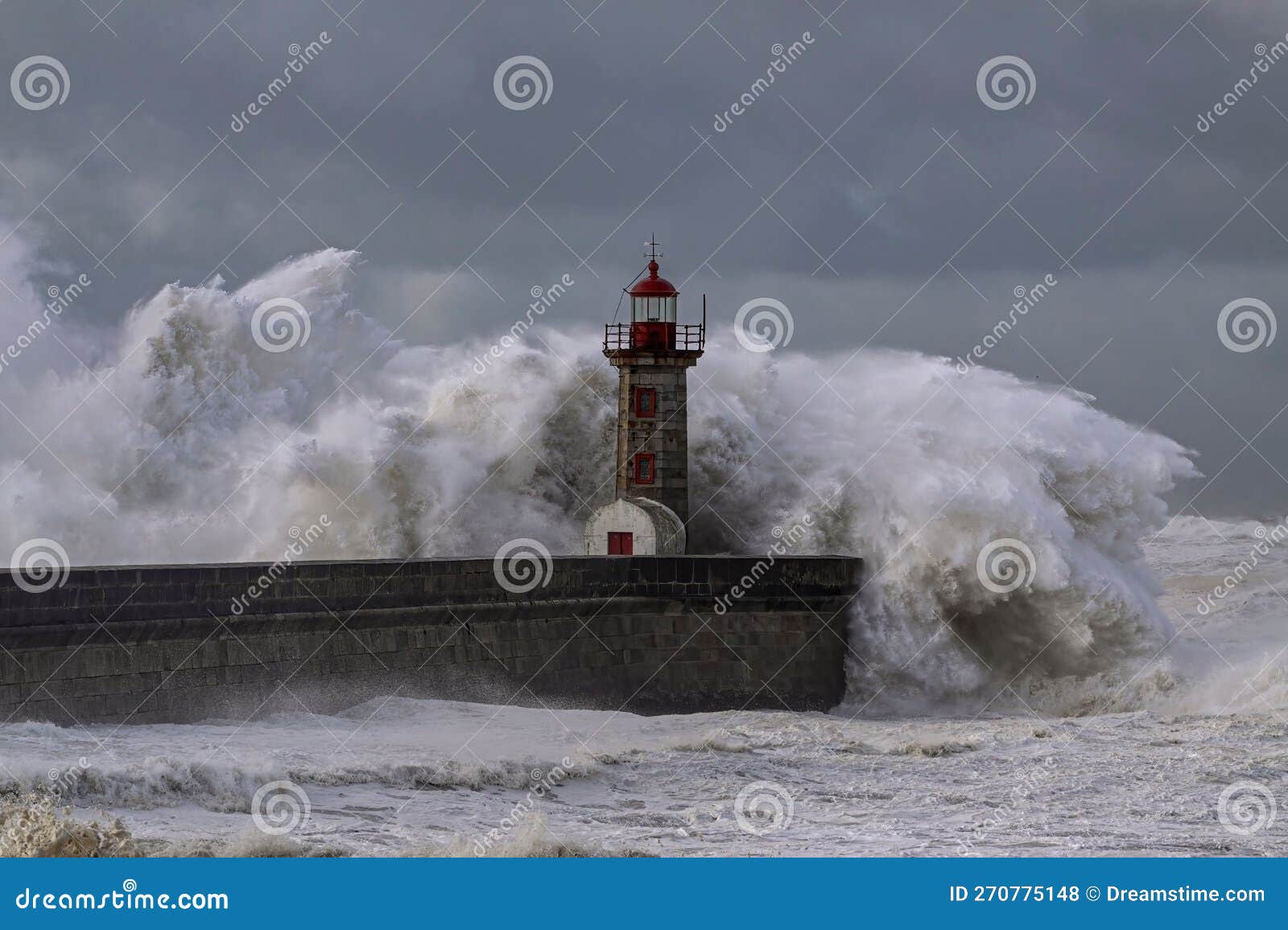 Waves Crash into a Lighthouse on the Ocean As a Large Wave Crashes ...