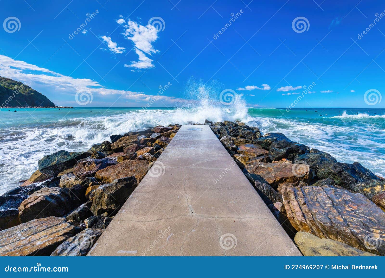 Waves crash on rocky jetty stock image. Image of rock - 274969207