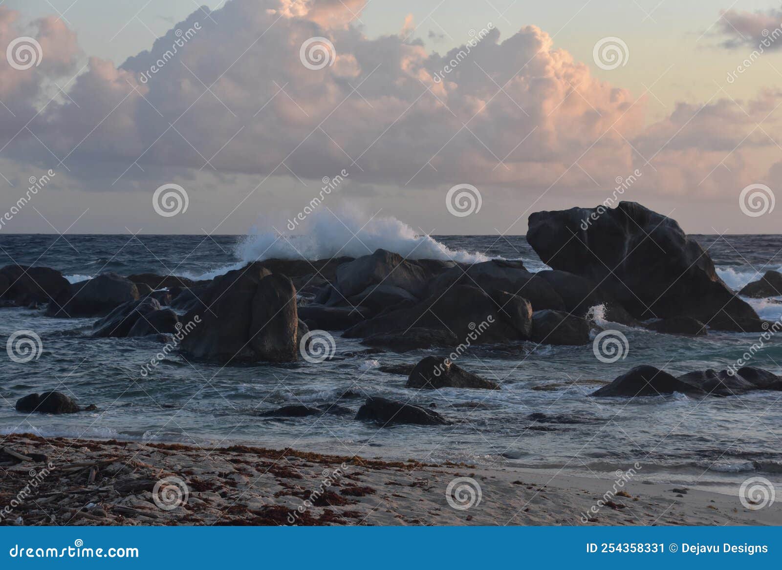 Waves Crashing on Rock Formations Under Pink Clouds Stock Image - Image ...