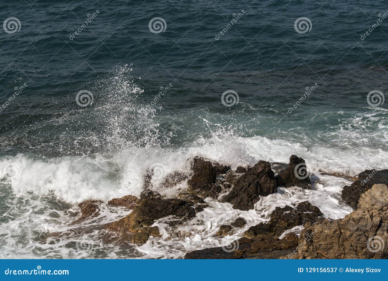Waves crashing on rocks stock image. Image of wave, crashing - 129156537
