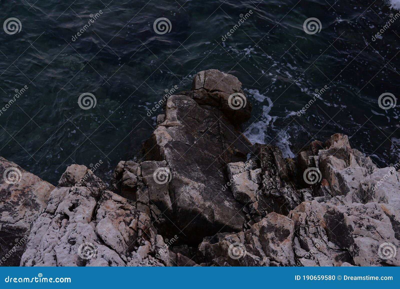Waves hitting the stones stock photo. Image of france - 190659580