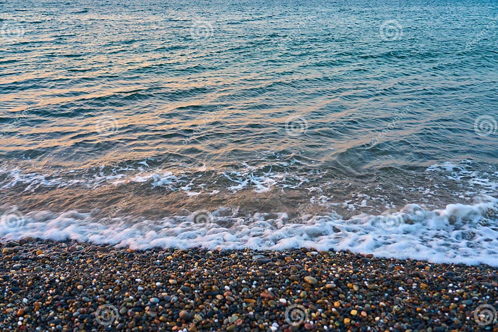 Waves on a Pebble Beach on a Sunset. Stock Photo - Image of pebble ...