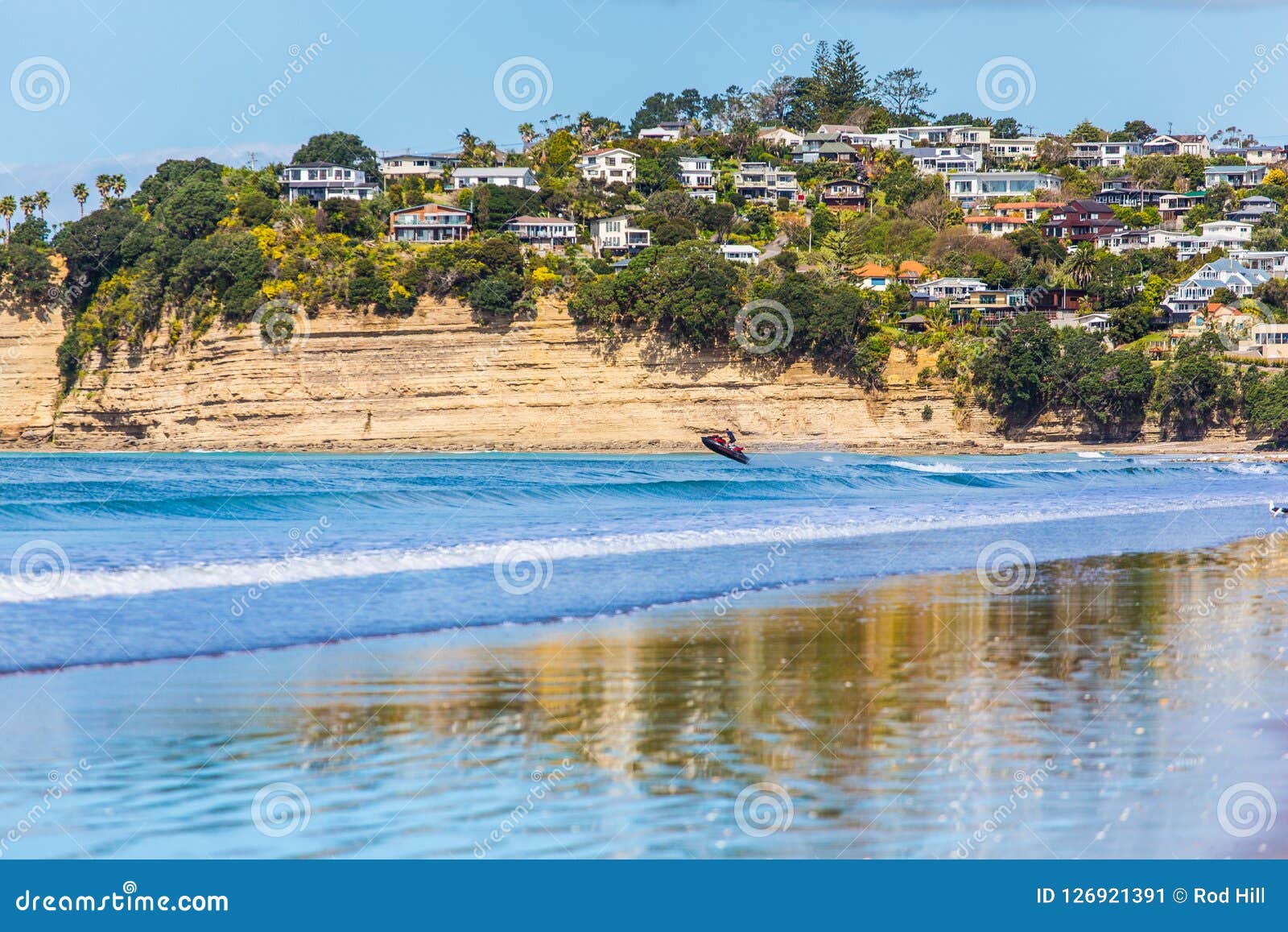 Waves roll into the beach stock image. Image of jetski - 126921391