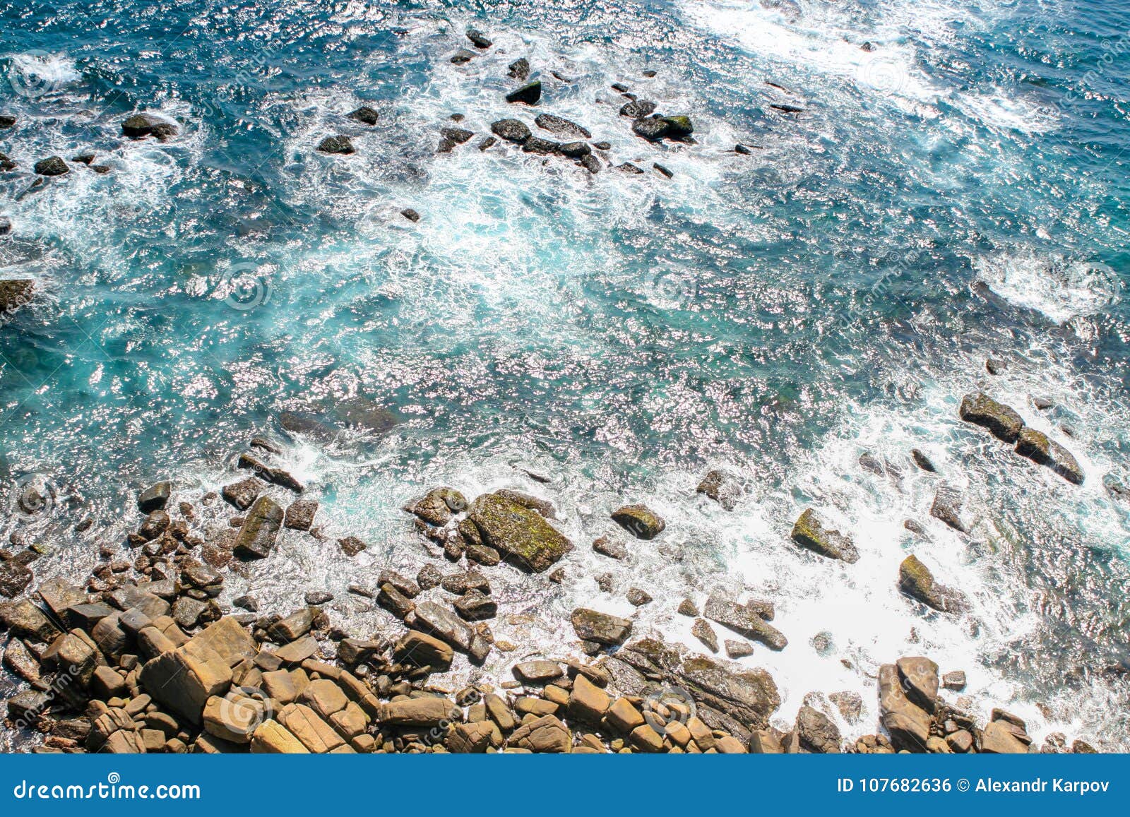 Waves rush into the rocks stock photo. Image of shore - 107682636