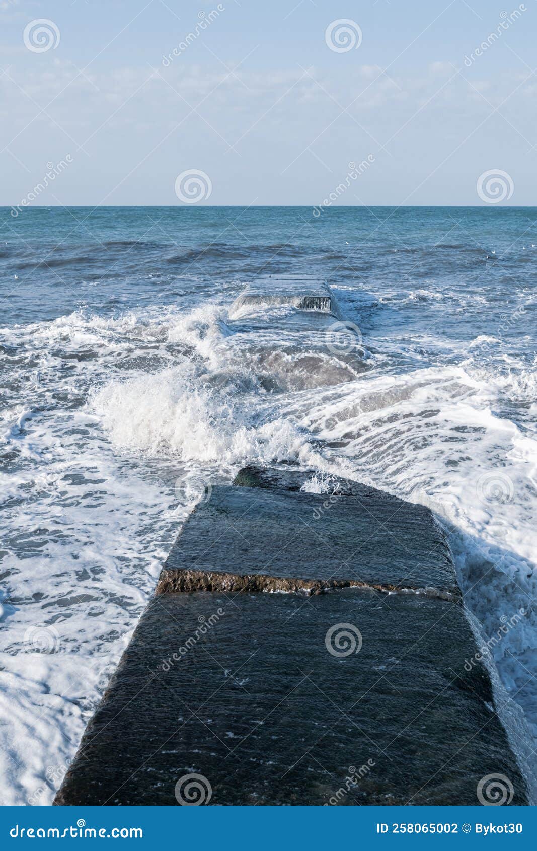 Waves crash on the pier stock photo. Image of background - 258065002