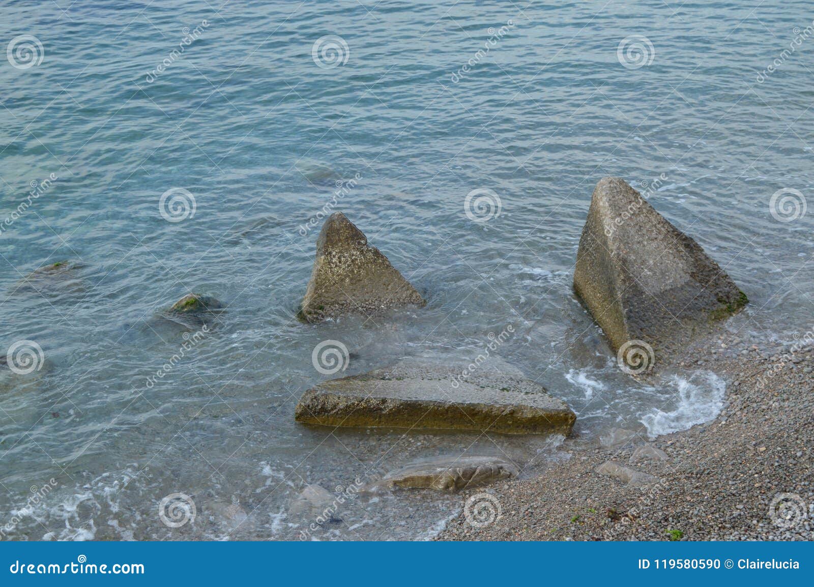 The Waves of the Sea Beating on the Huge Boulders on the Shore Stock ...