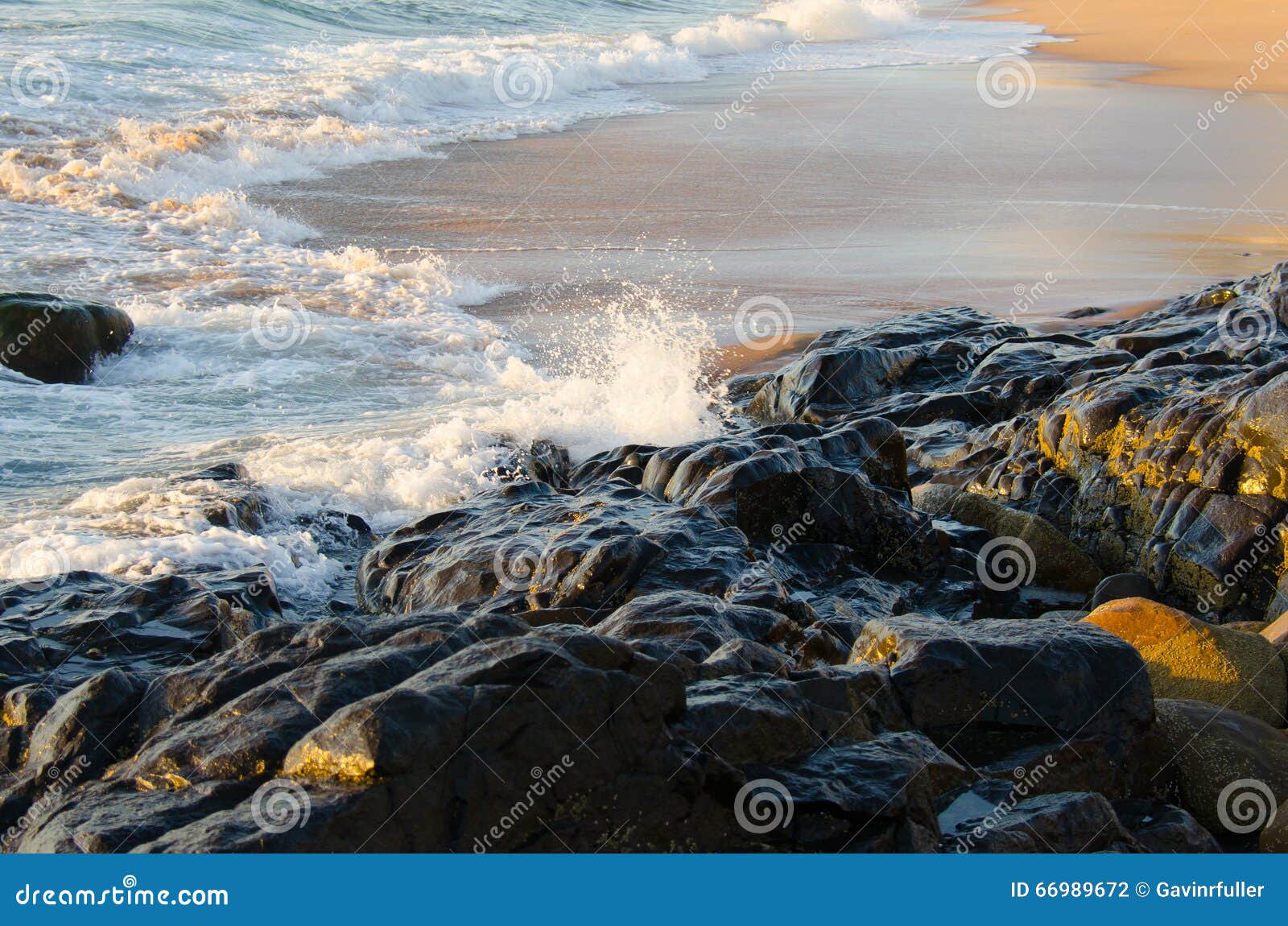 Waves Splashing Against Lit Rocks Stock Photo - Image of dramatic ...