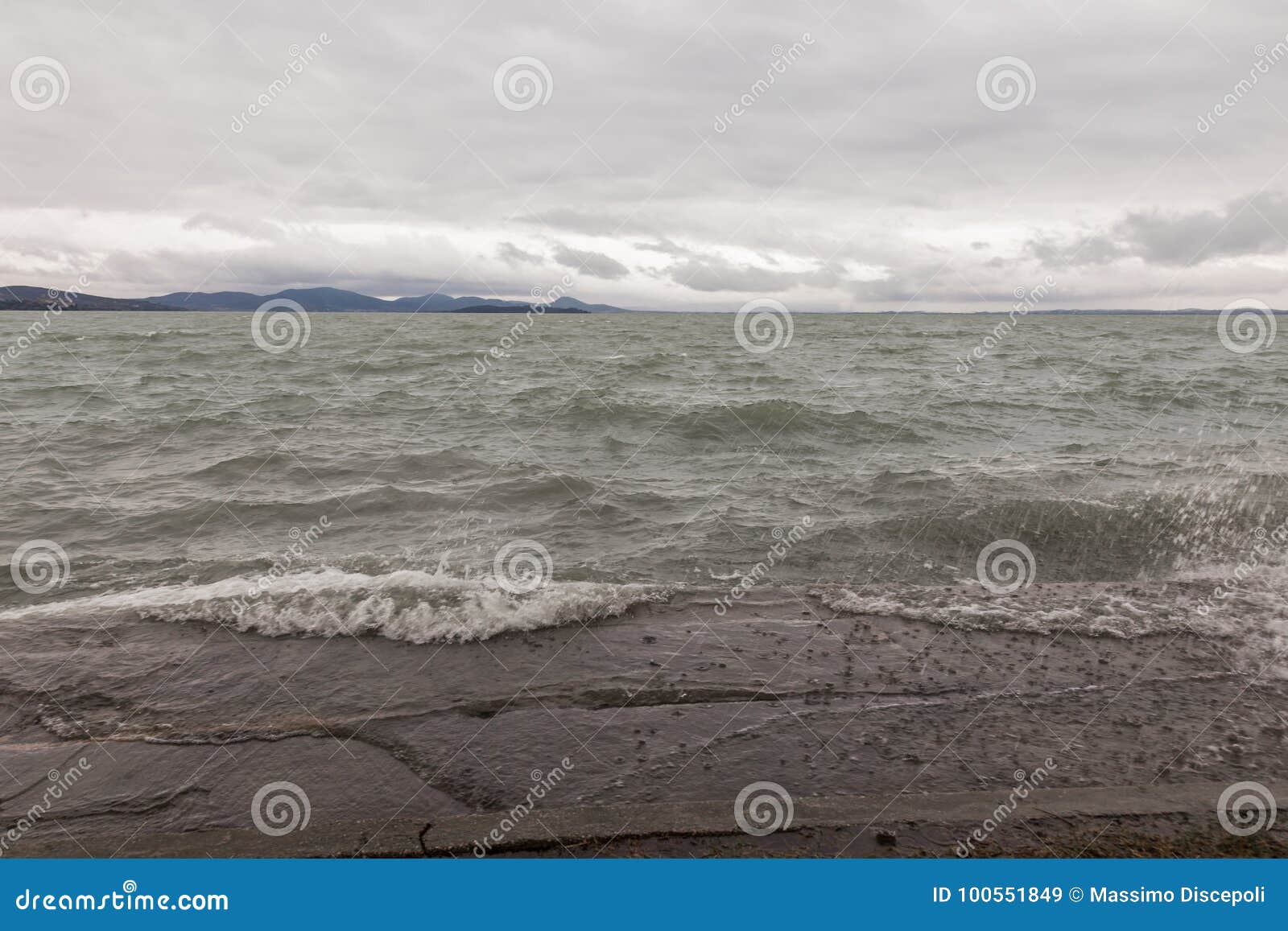 Waves Splashing on a Pavement on a Lake Shore Stock Image - Image of ...