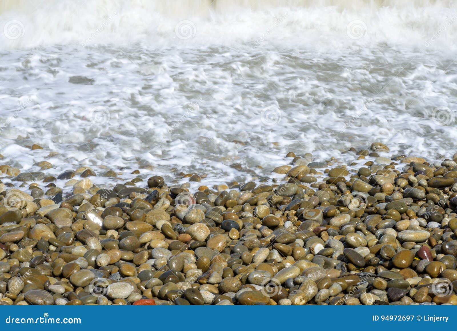 Waves on stone beach. stock image. Image of heap, brown - 94972697
