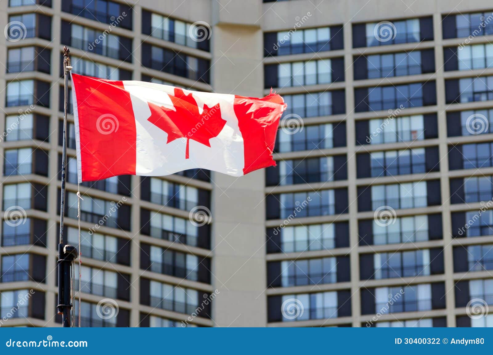 Waving Canadian Flag and Building in the Background Stock Photo - Image ...