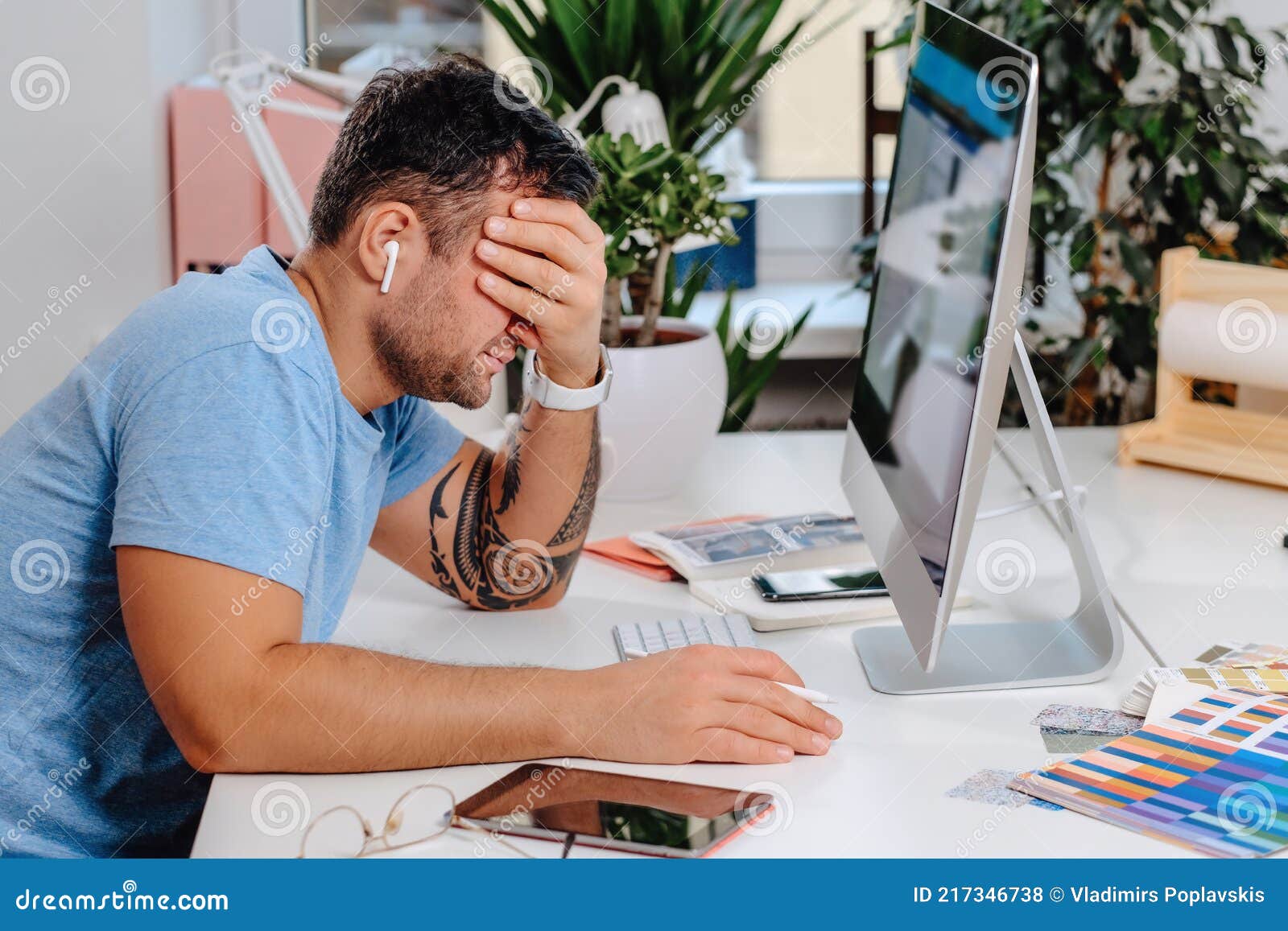Overworked Office Worker Sits at Table at His Work in Office Room Stock ...