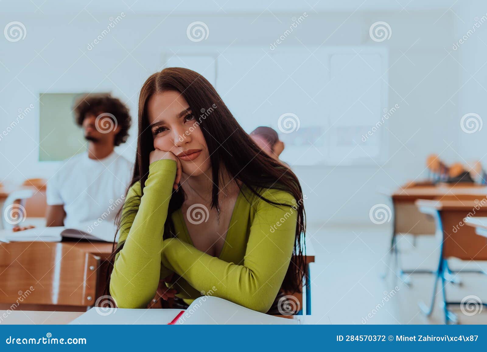 A Weary-looking Student Sitting in Front of a Group of Diverse Students ...
