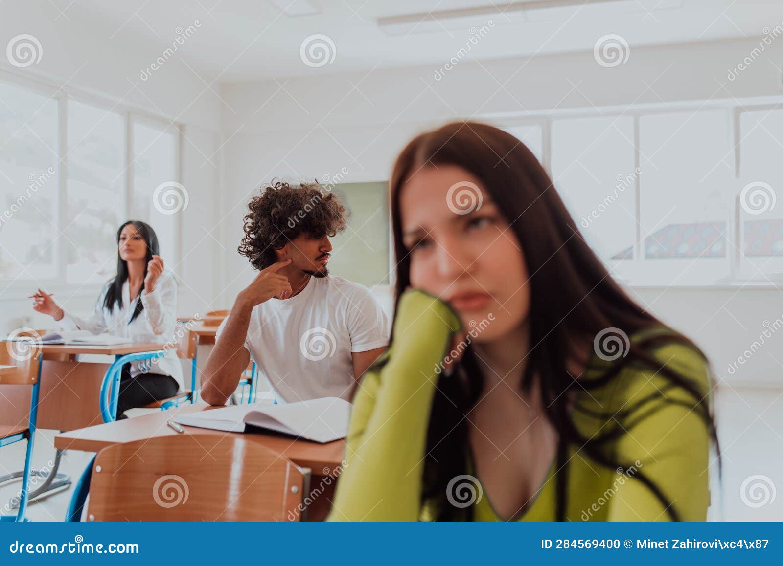 A Weary-looking Student Sitting in Front of a Group of Diverse Students ...