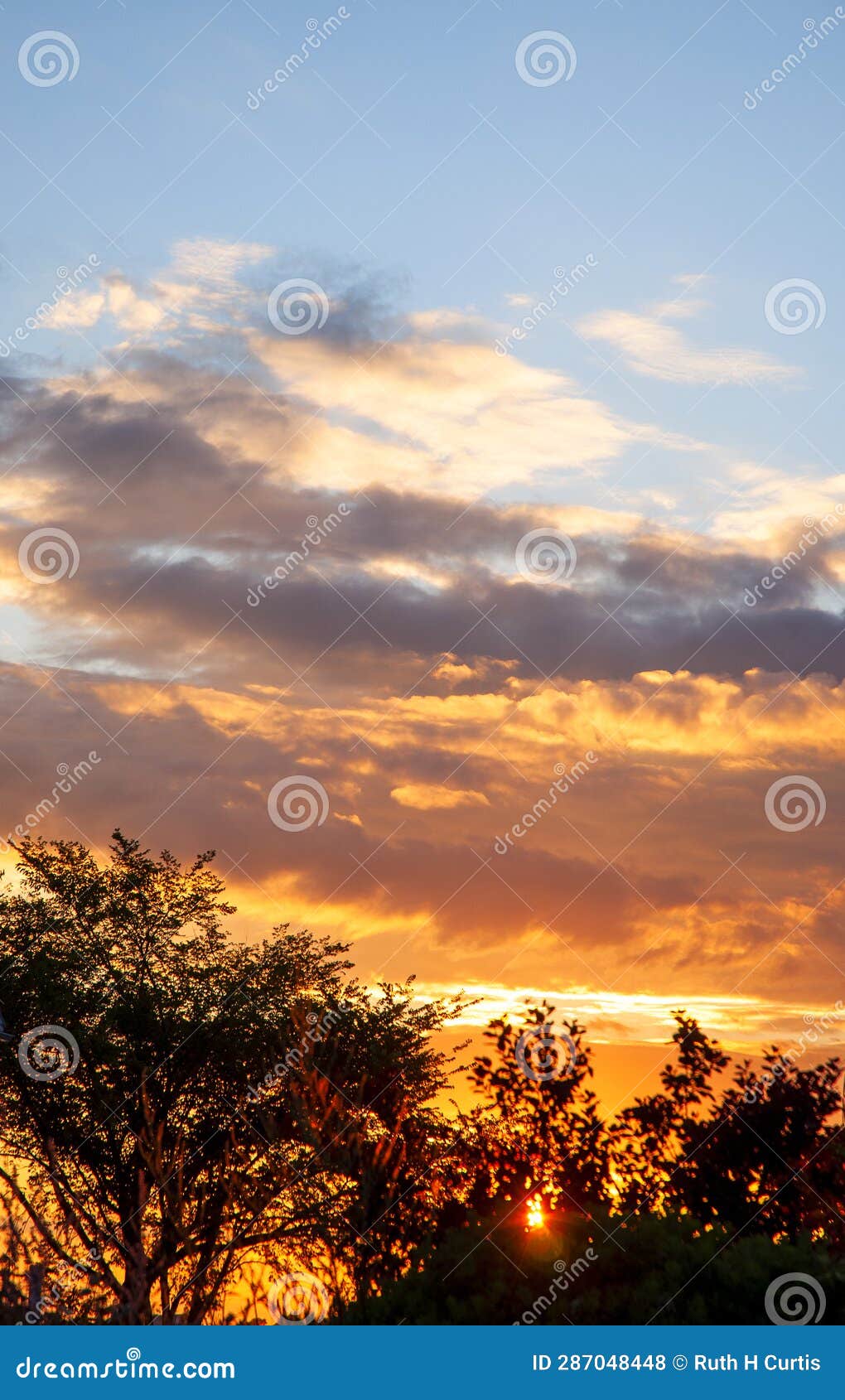 Setting Sun Over the Landscape with Beauty in the Clouds Stock Photo ...