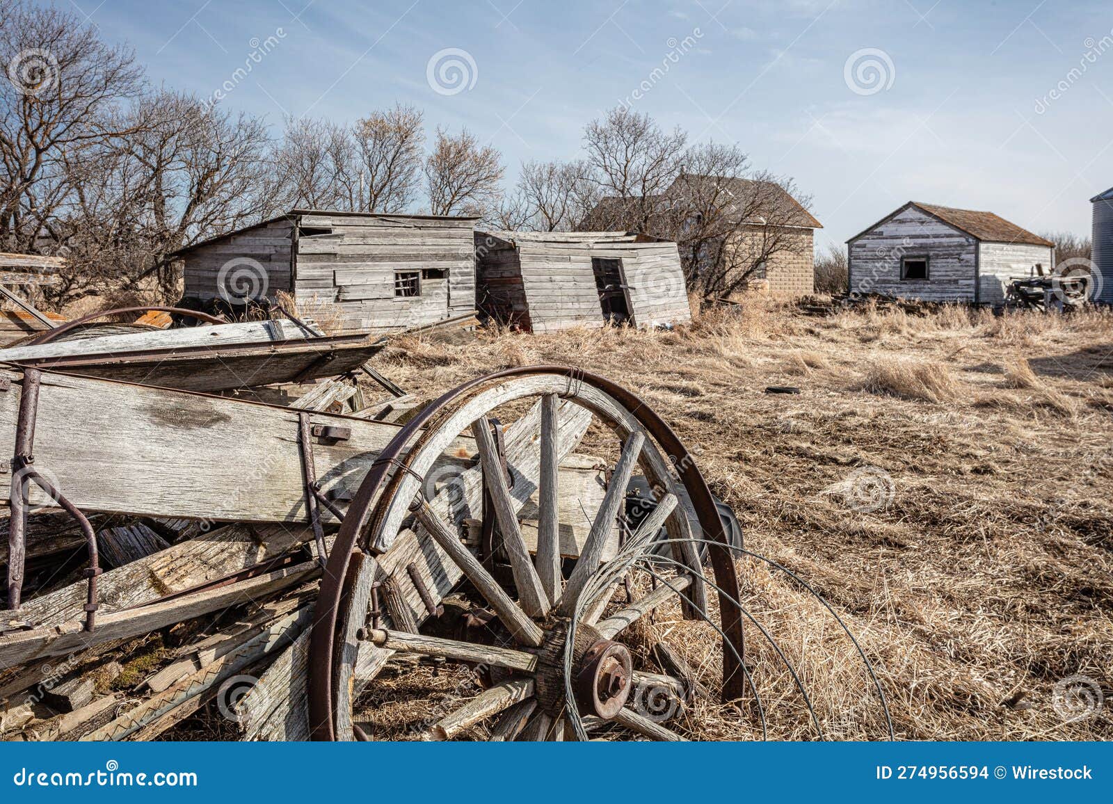 Weathered and Aged Wheelbarrow in a Rural Landscape with Multiple Barns ...