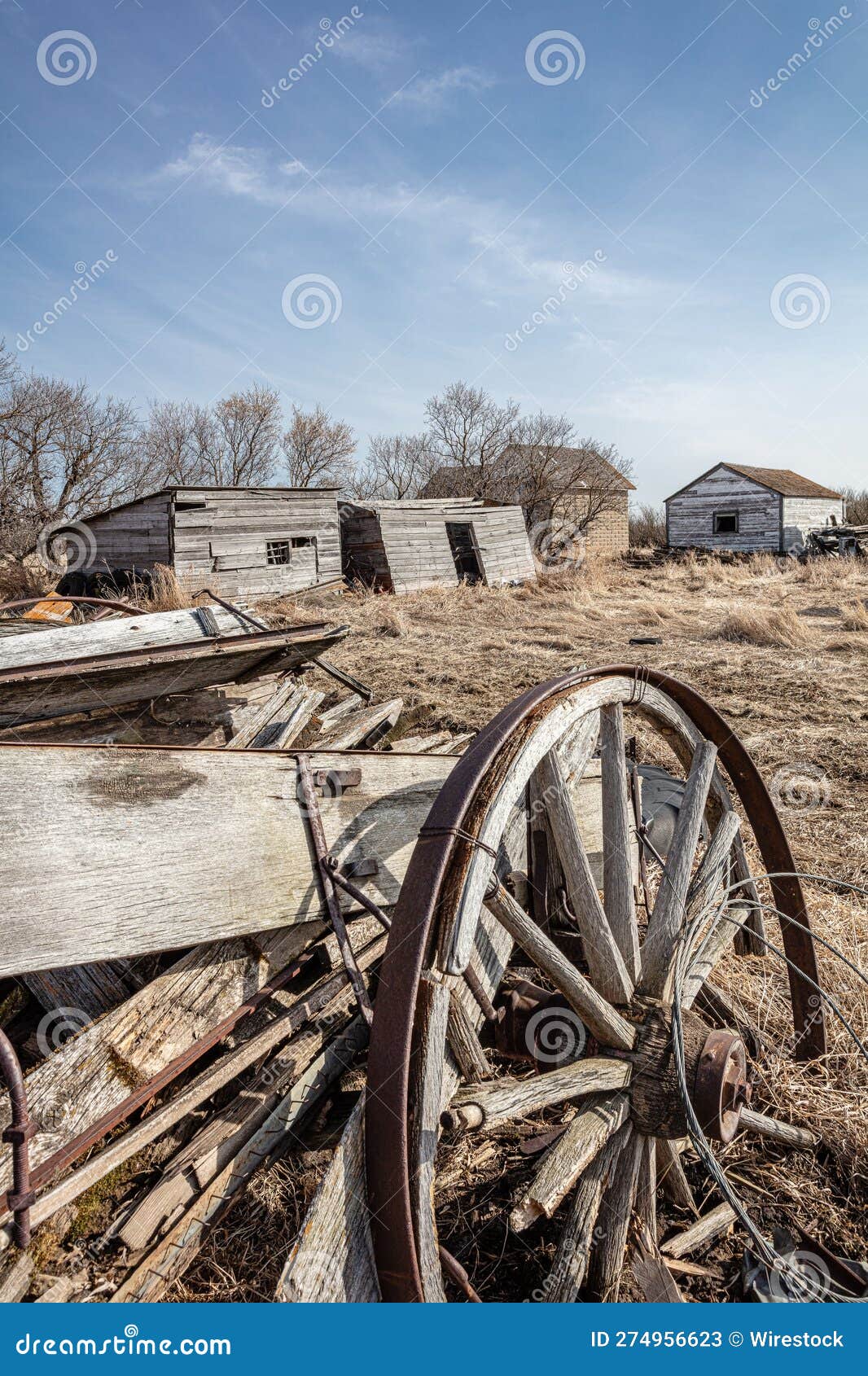 Weathered and Aged Wheelbarrow in a Rural Landscape with Multiple Barns ...