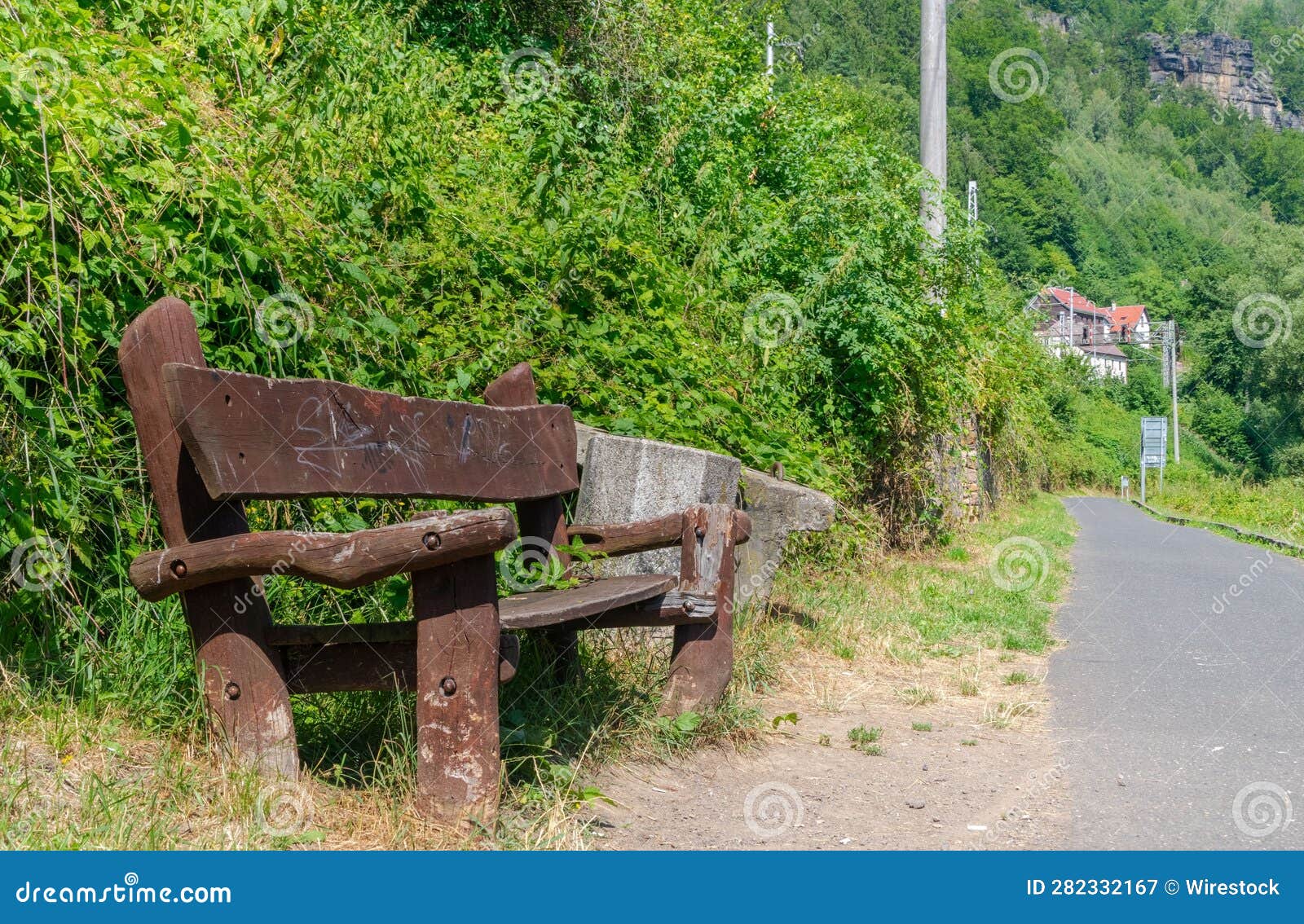 An Old Bench that is Sitting on the Side of the Road Stock Image ...