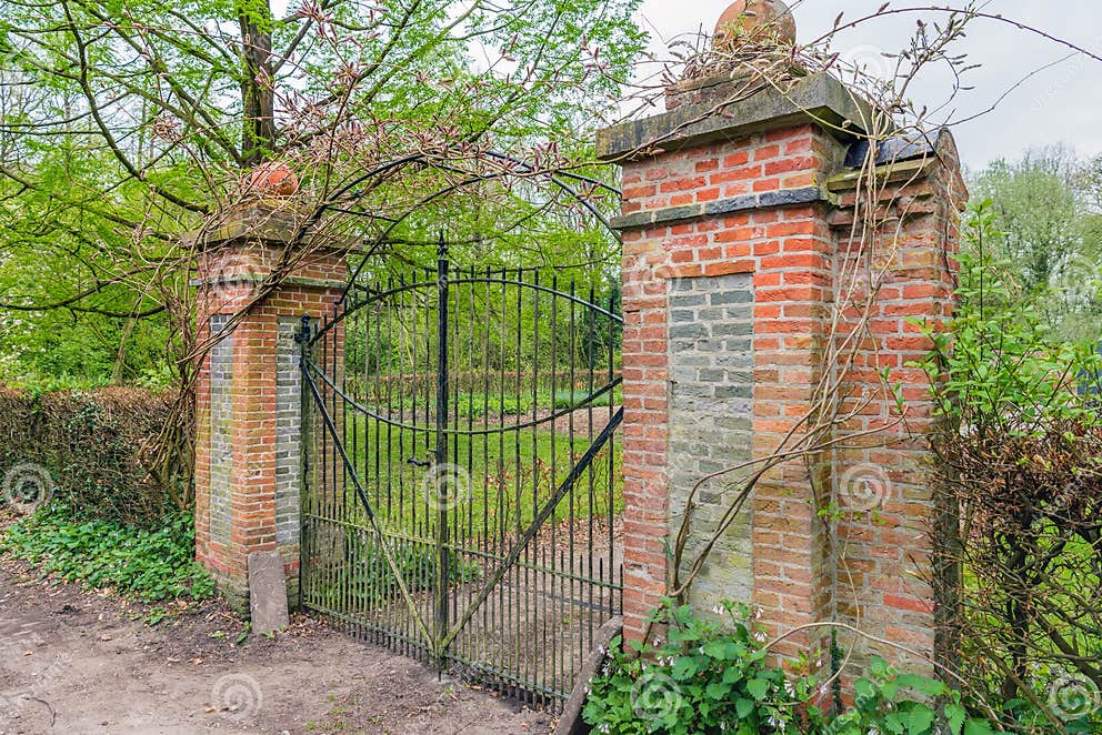 Weathered Black Painted Iron Gate between Brick Pillars Stock Photo ...