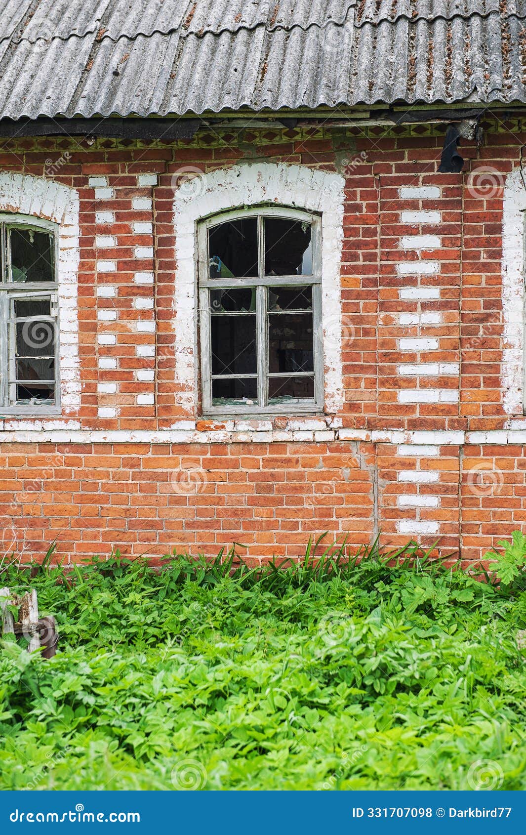Weathered Brick House with Shattered Windows Stands Isolated in ...