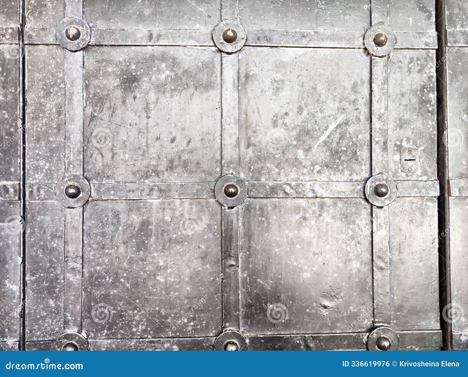 A Weathered Metal Door Showcases Riveted Panels, Reflecting the Charm ...